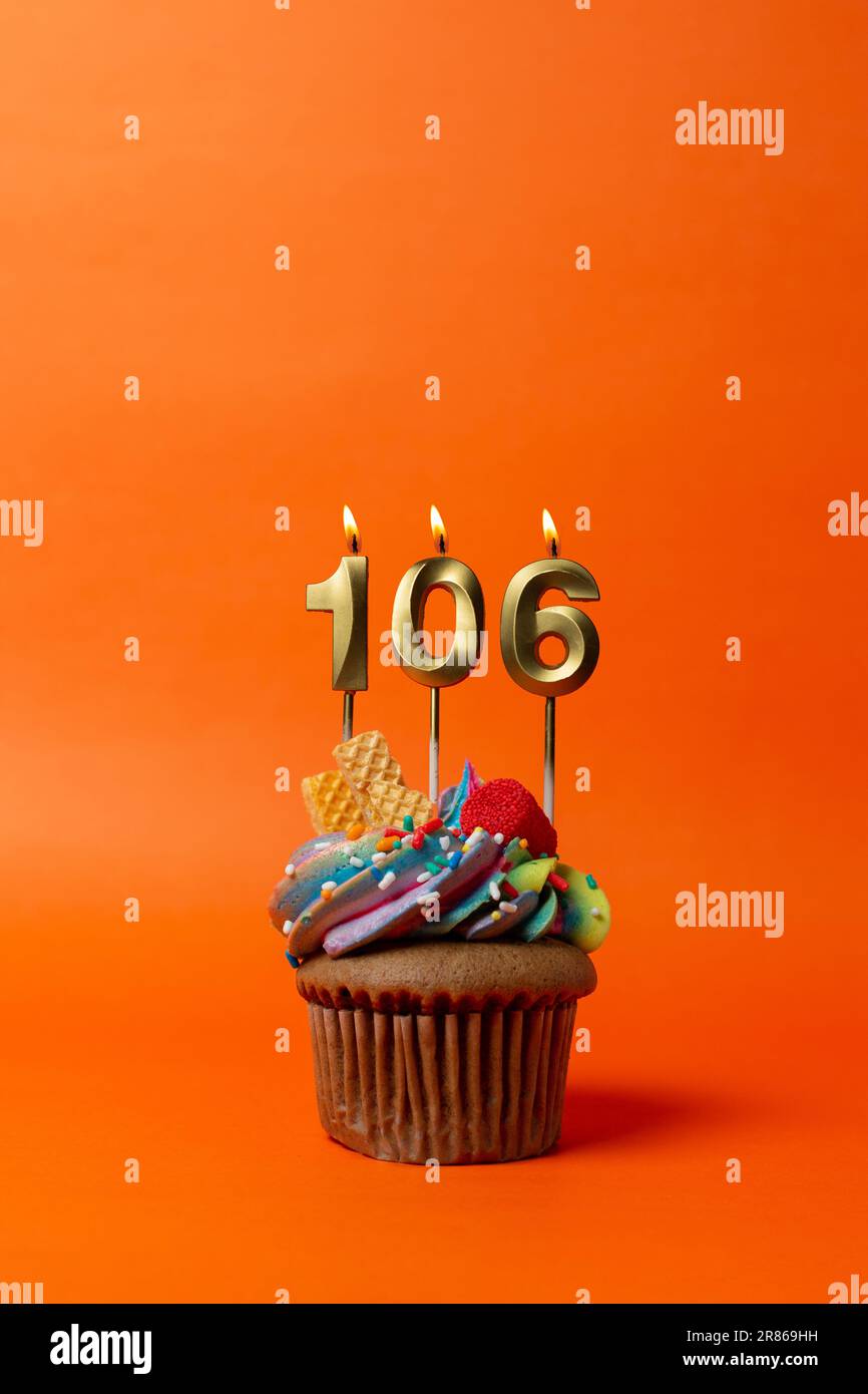 birthday cake with number 106 - cupcake on orange background with ...