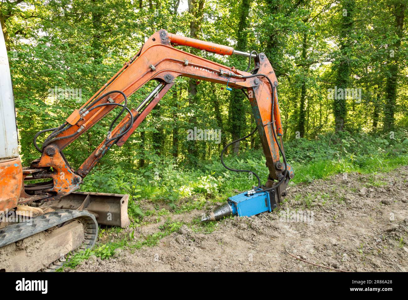 Log splitter mounted on a compact digger, High Bickington, North Devon ...