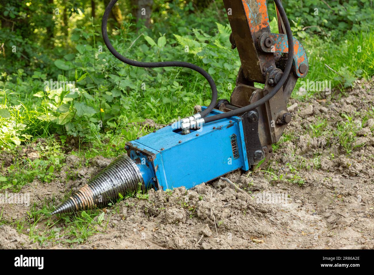 Log splitter mounted on a compact digger, High Bickington, North Devon ...