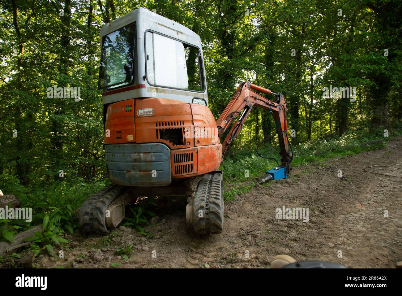 Log splitter mounted on a compact digger, High Bickington, North Devon ...