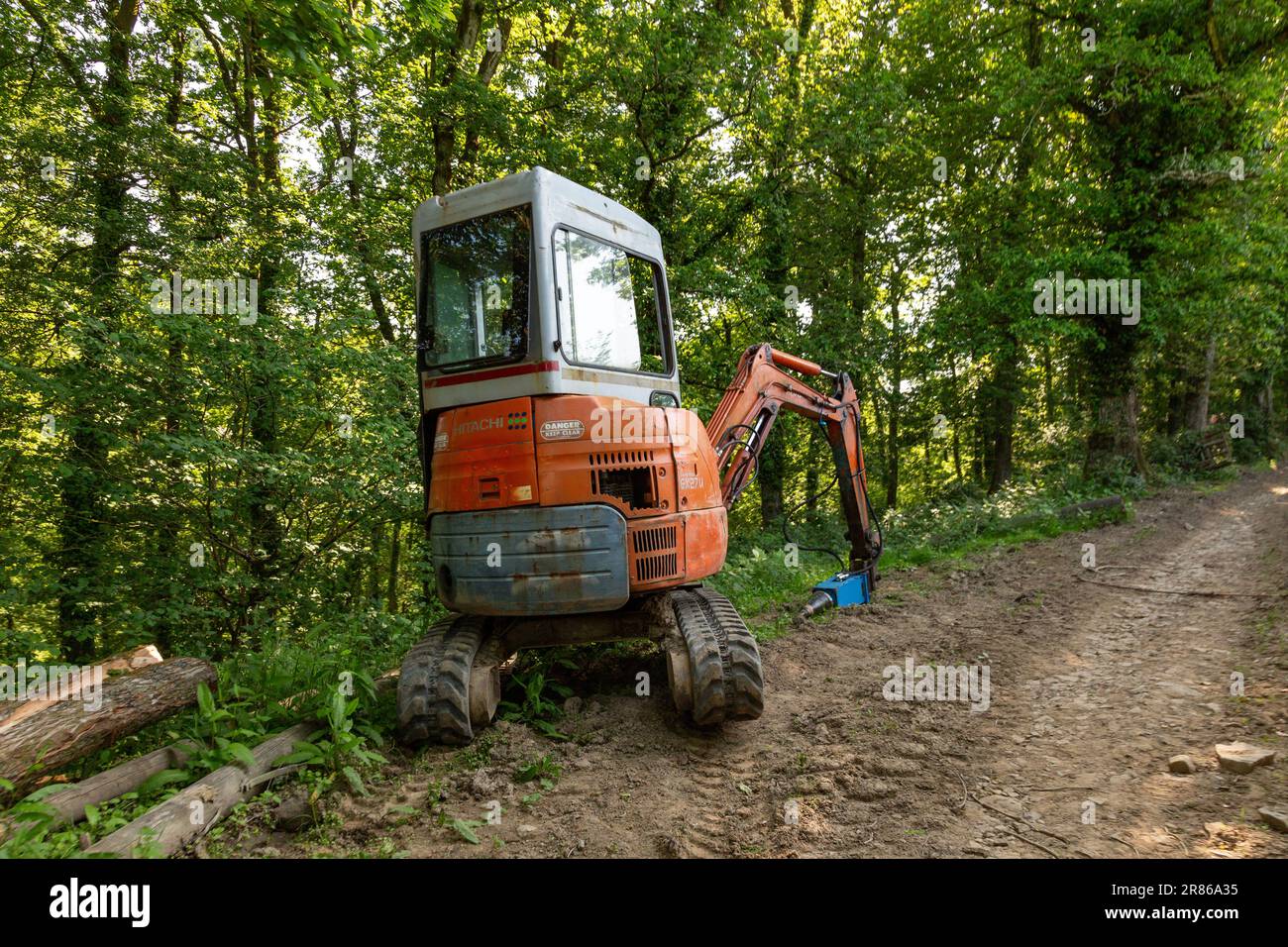 Log splitter mounted on a compact digger, High Bickington, North Devon ...