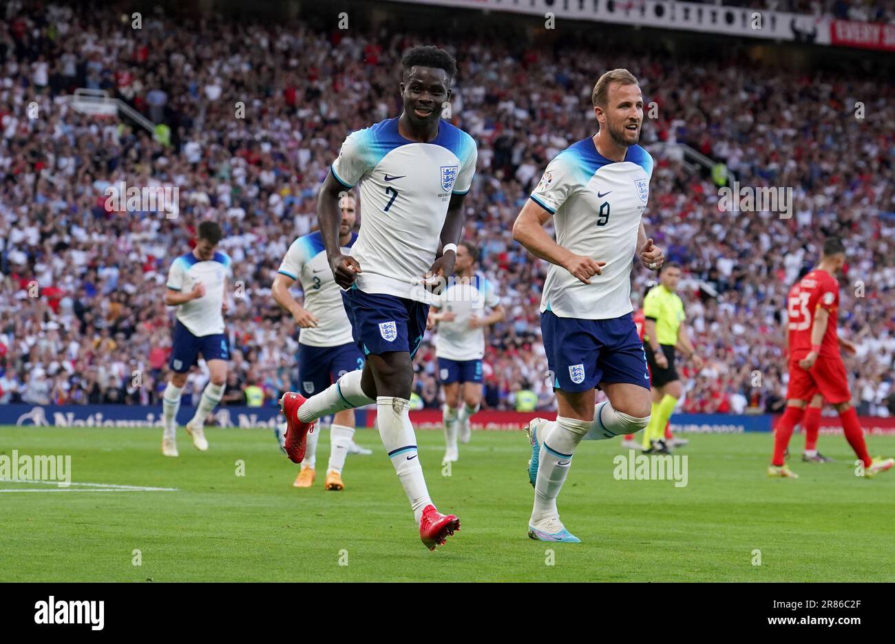 England's Bukayo Saka (left) celebrates with Harry Kane after scoring ...