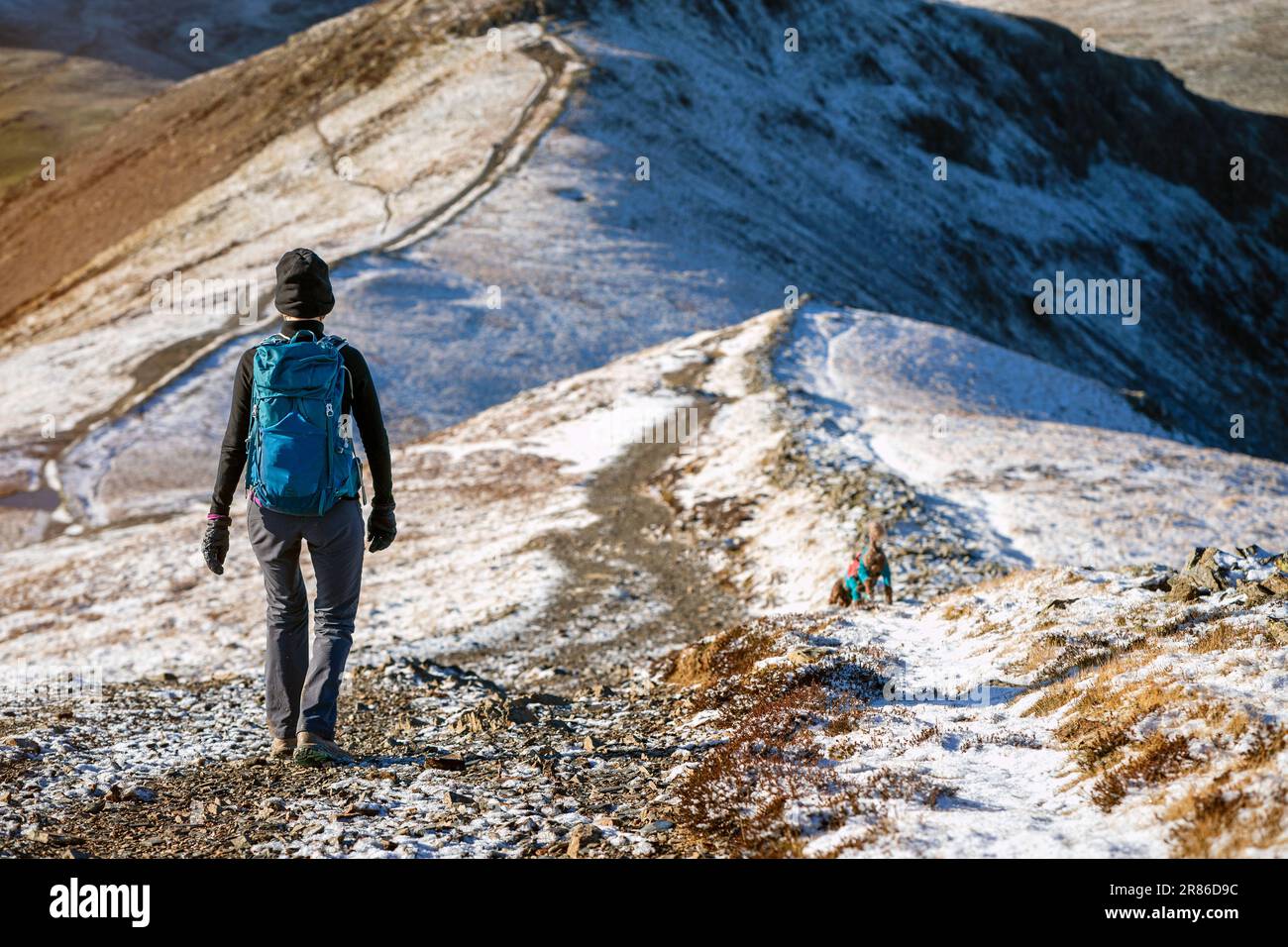 A female hiker and their dog walking down towards Sand Hill from the ...