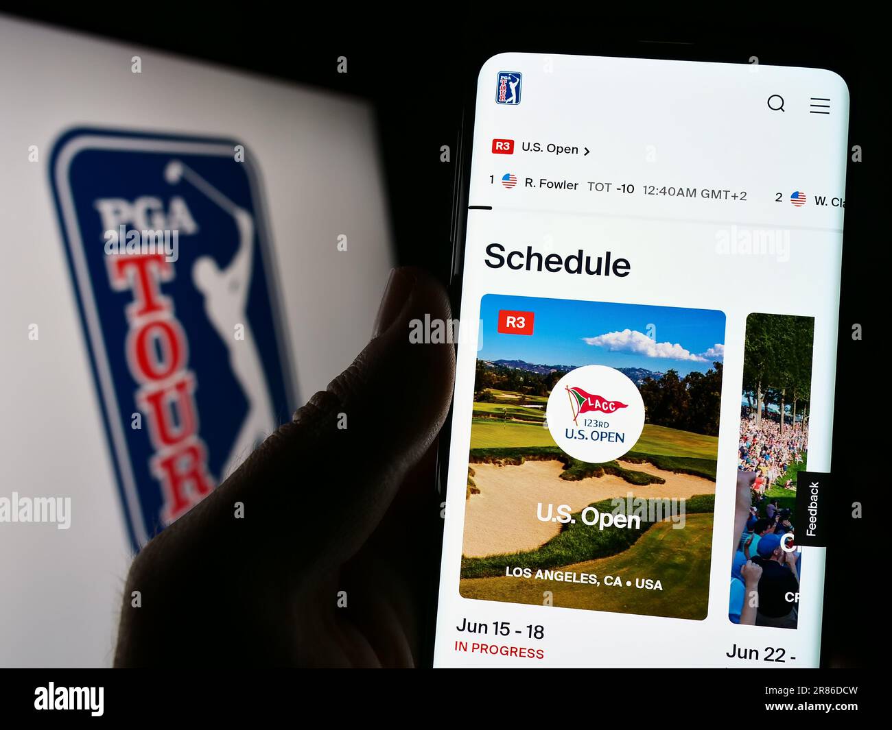 Person holding cellphone with webpage of US golf organization PGA Tour ...