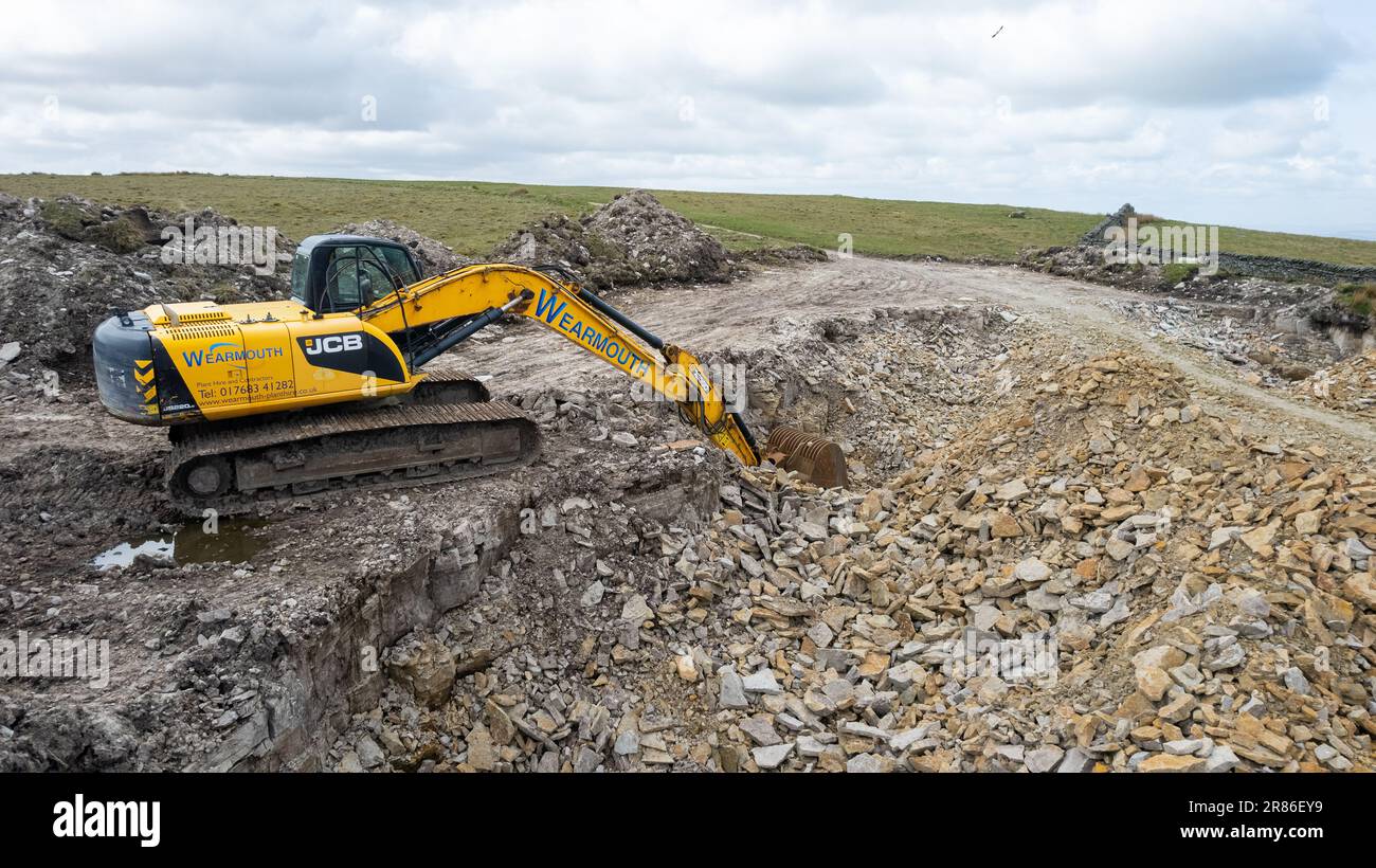 360 Excavator in a quarry for stone to be used in dry stone walling on ...