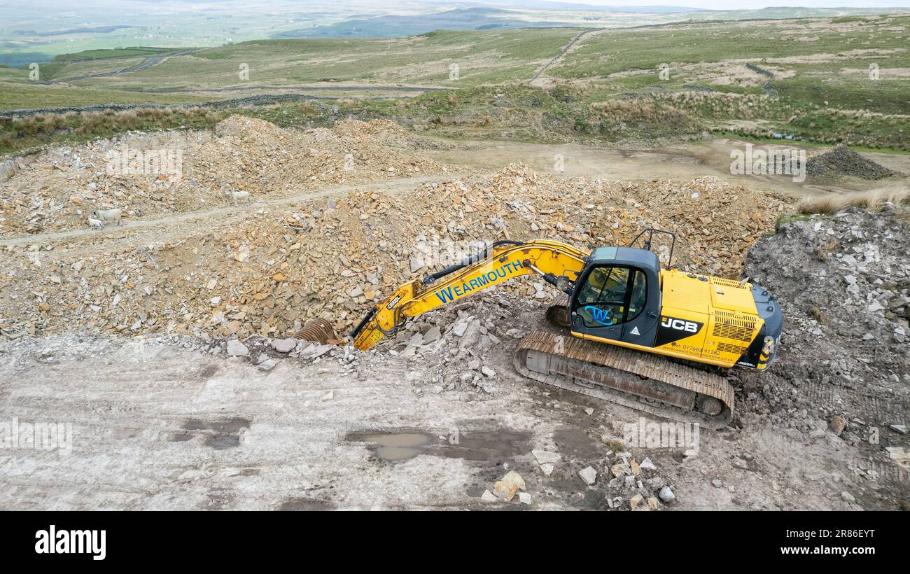 360 Excavator in a quarry for stone to be used in dry stone walling on ...
