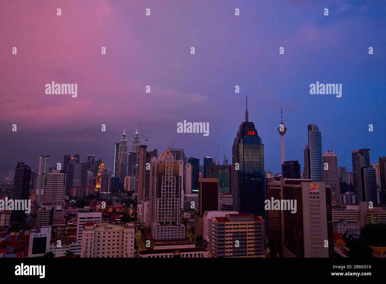 An incredible pink and purple sunset over a modern big city. Kuala ...