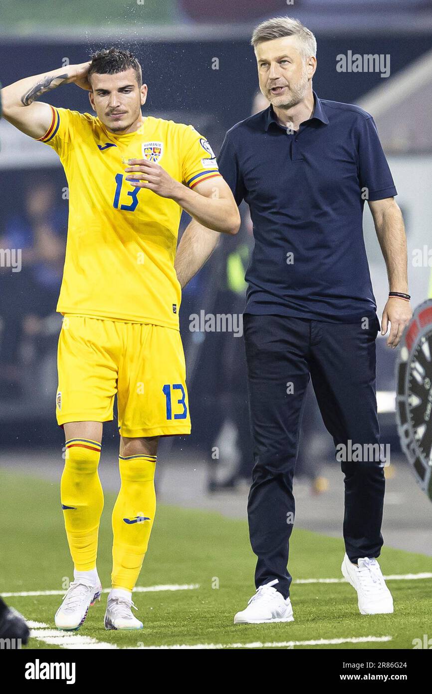 Romania's head coach Edward Iordanescu, right, talks to Romania's ...