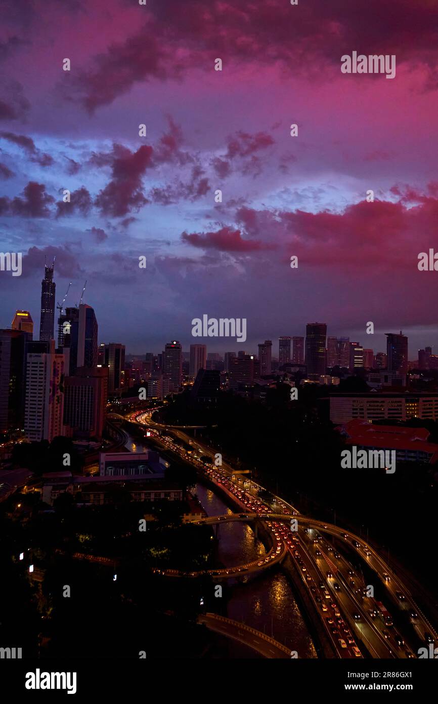 An incredible pink and purple sunset over a modern big city Stock Photo ...