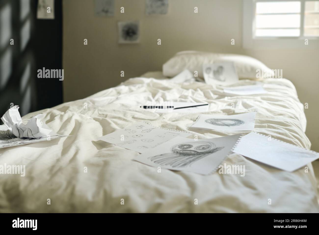 Front view of double bed with group of drawings of phobias of mentally ...