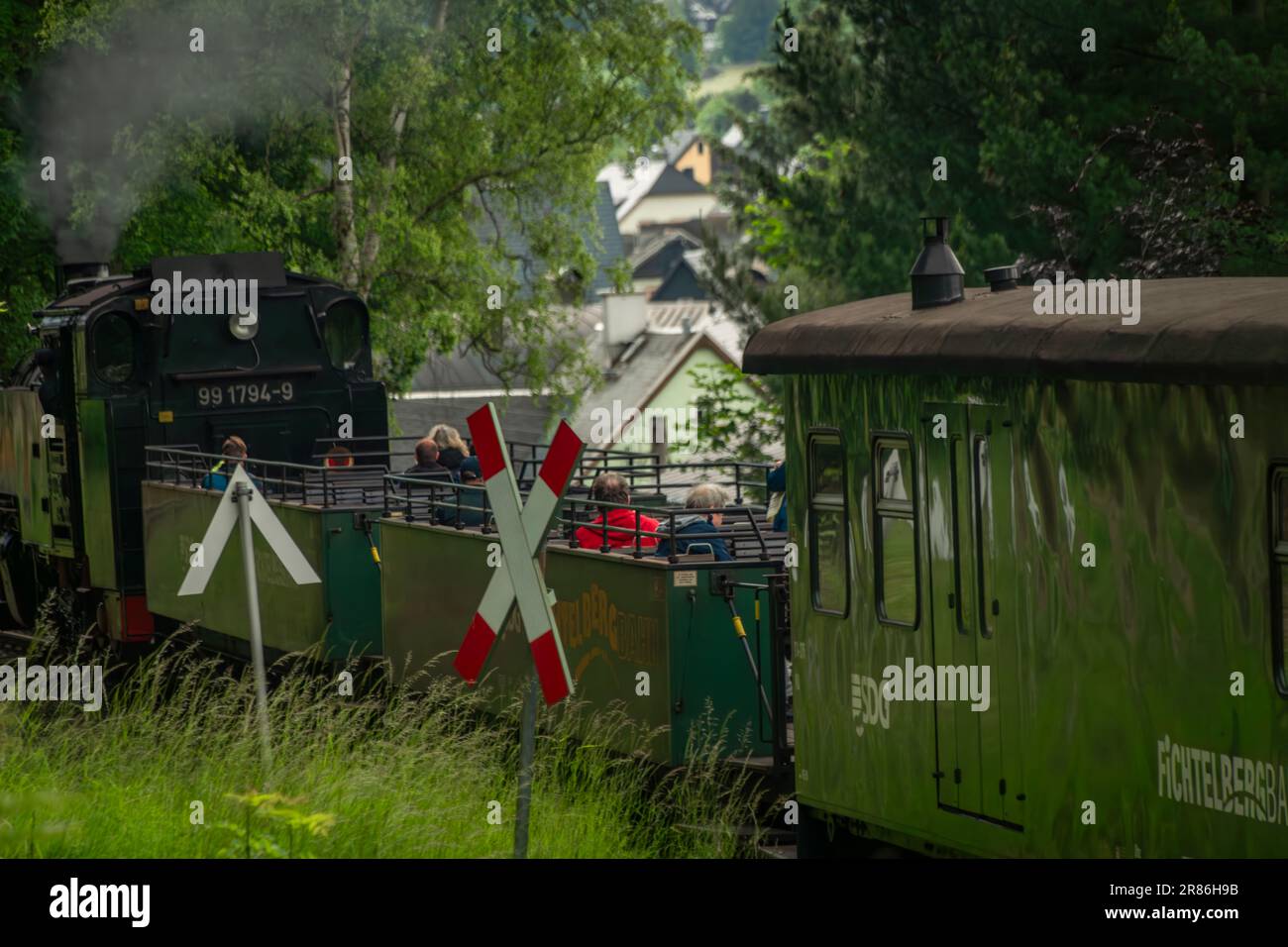 Steam engine train with passengers in fresh summer day near Neudorf ...