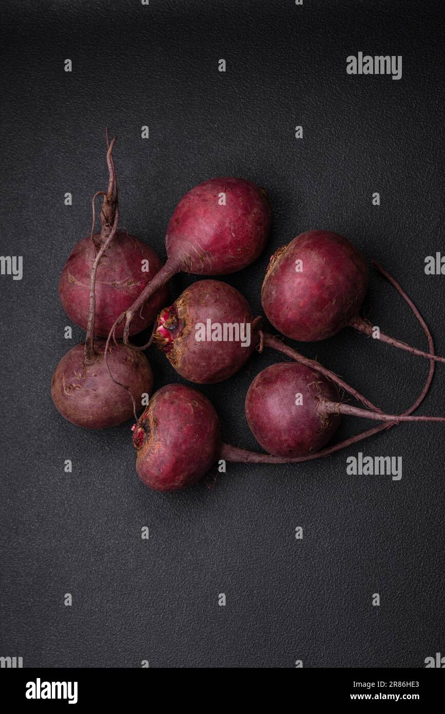 Fresh raw beetroot in the form of tubers on a textured concrete ...