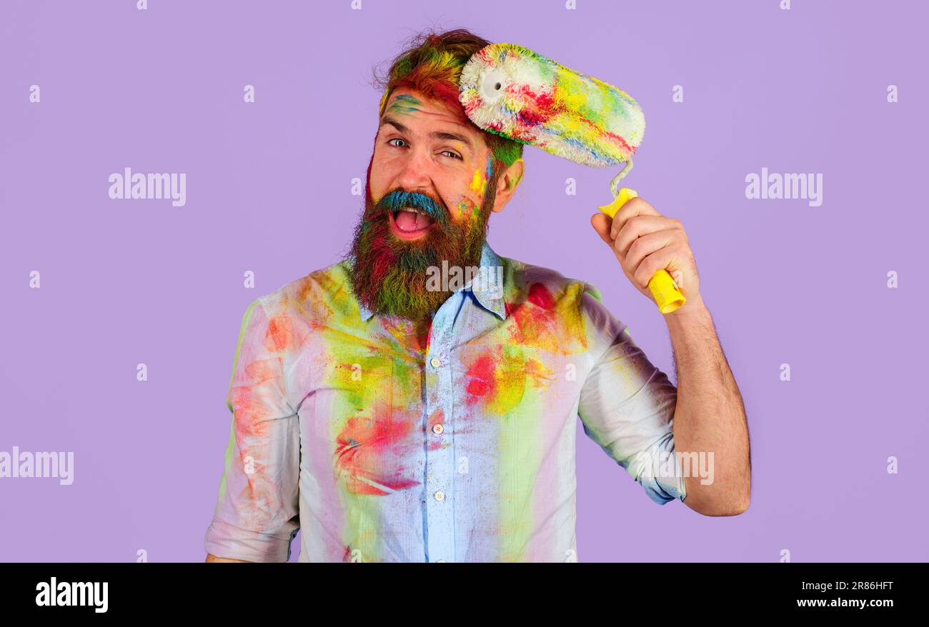 Professional painter with paint roller. Bearded painter in dirty dyed ...