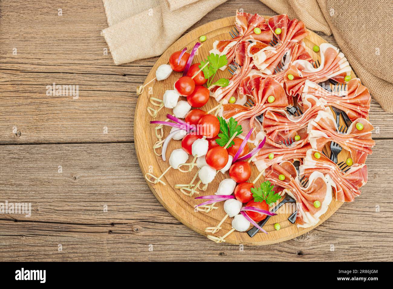 Set of picnic snacks on skewers. Jamon, mozzarella, cherry tomatoes ...