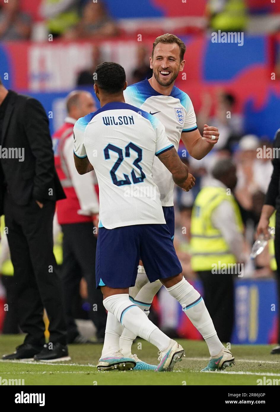 England's Harry Kane (right) jokes with Callum Wilson on the touchline ...