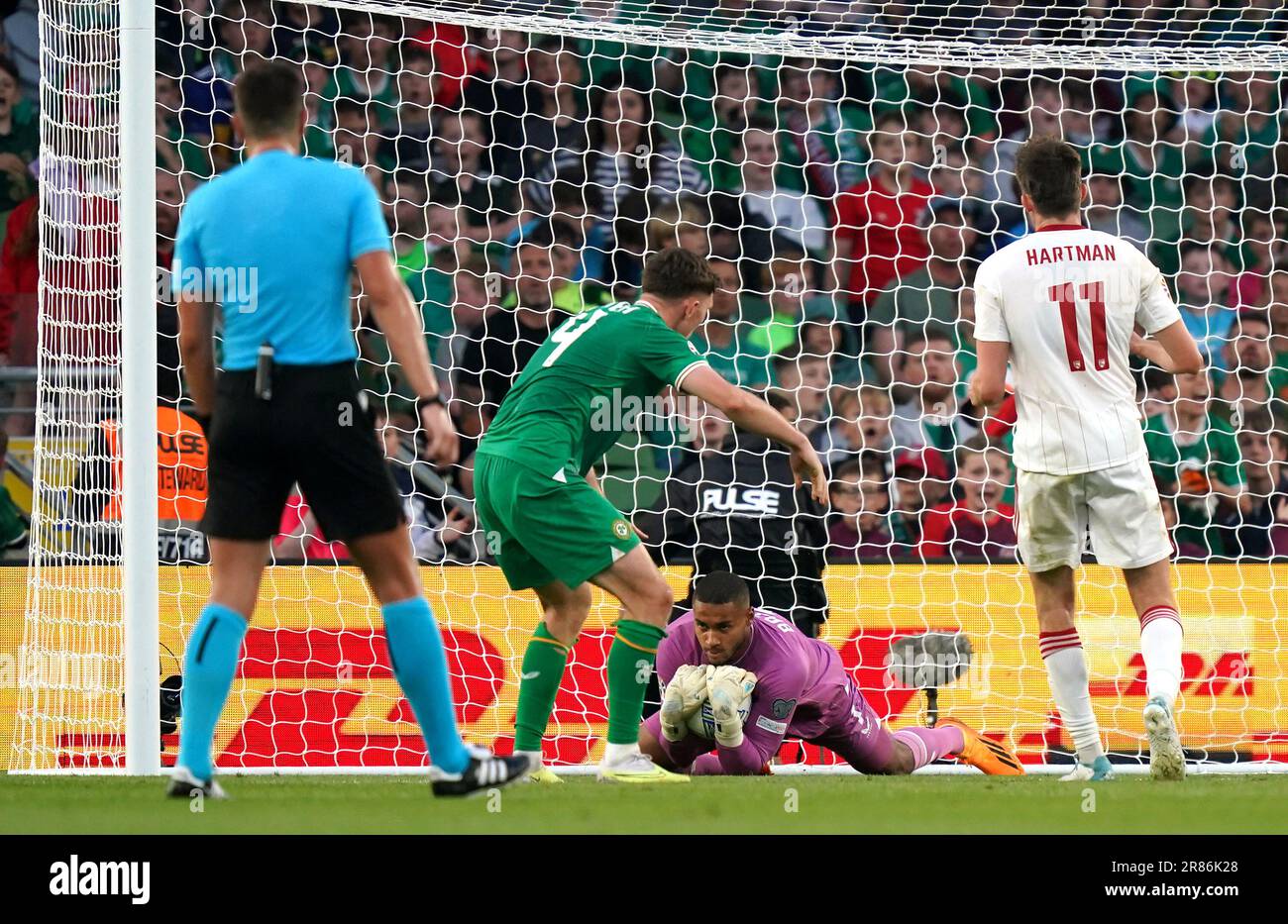 Republic of Ireland goalkeeper Gavin Bazunu (centre) makes a save ...