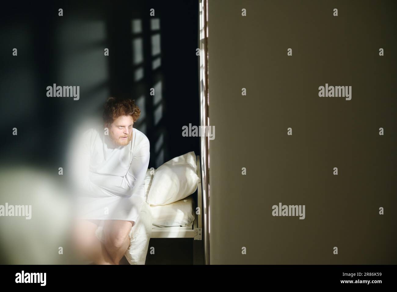 Focus on young deranged man suffering from strong mental disability ...