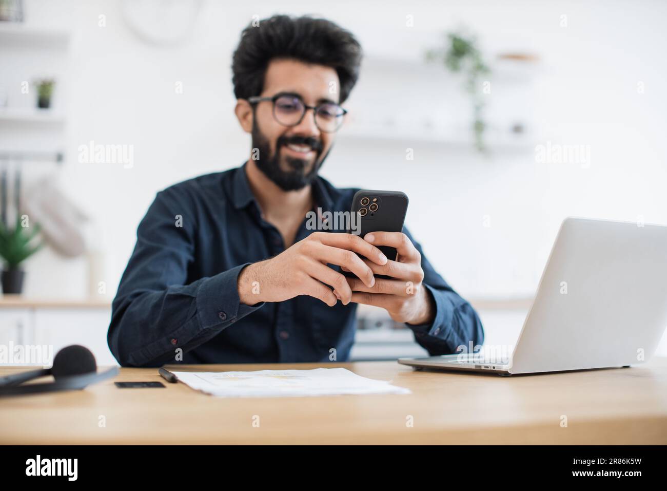 Focus on modern black cell phone being used by arabian adult in ...