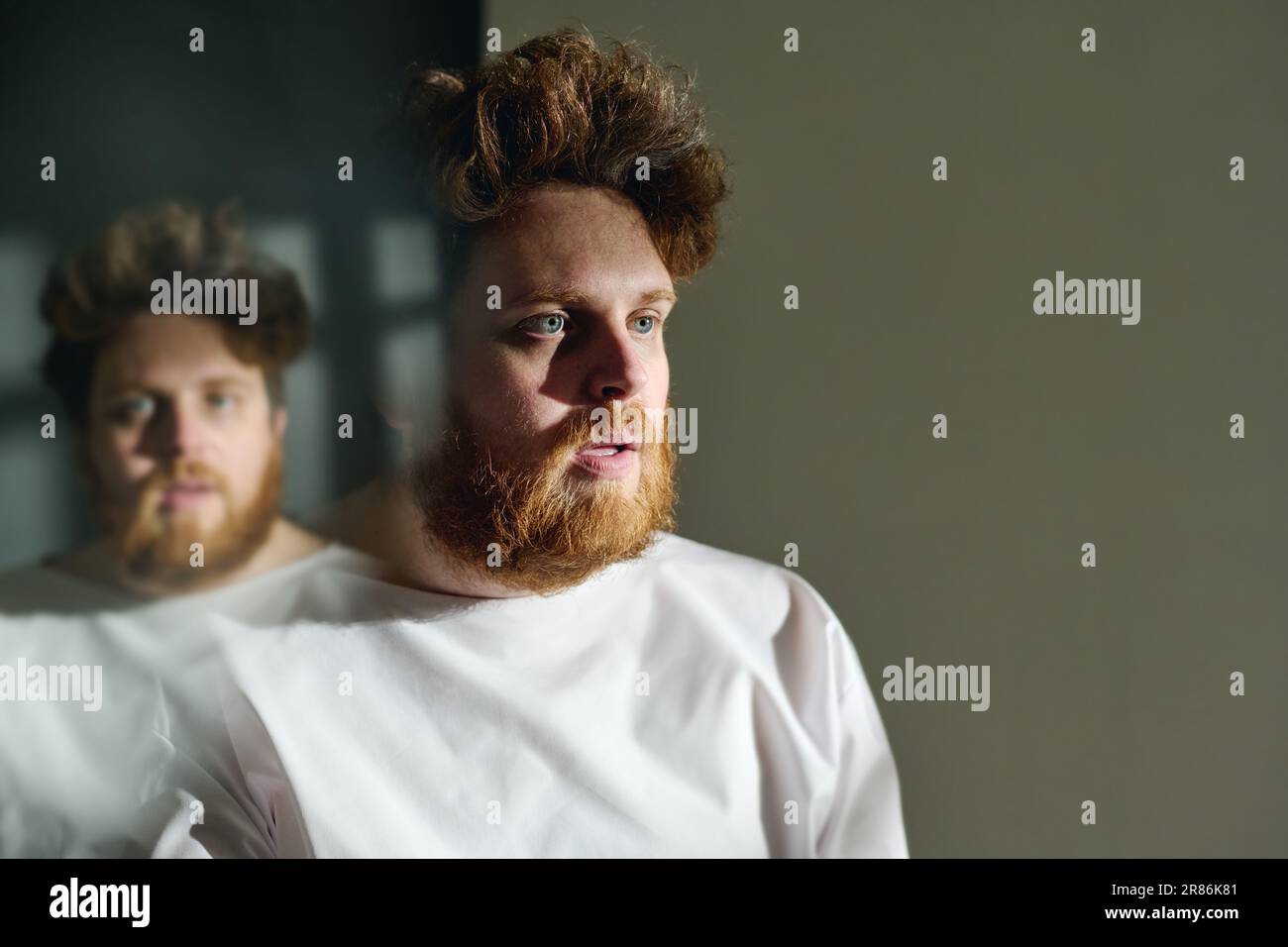 Young bearded insane male patient of mental clinics in straitjacket ...
