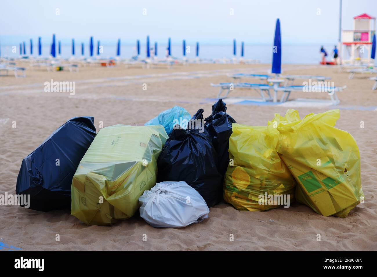 Spilled garbage the beach of the big city. Empty used dirty plastic ...