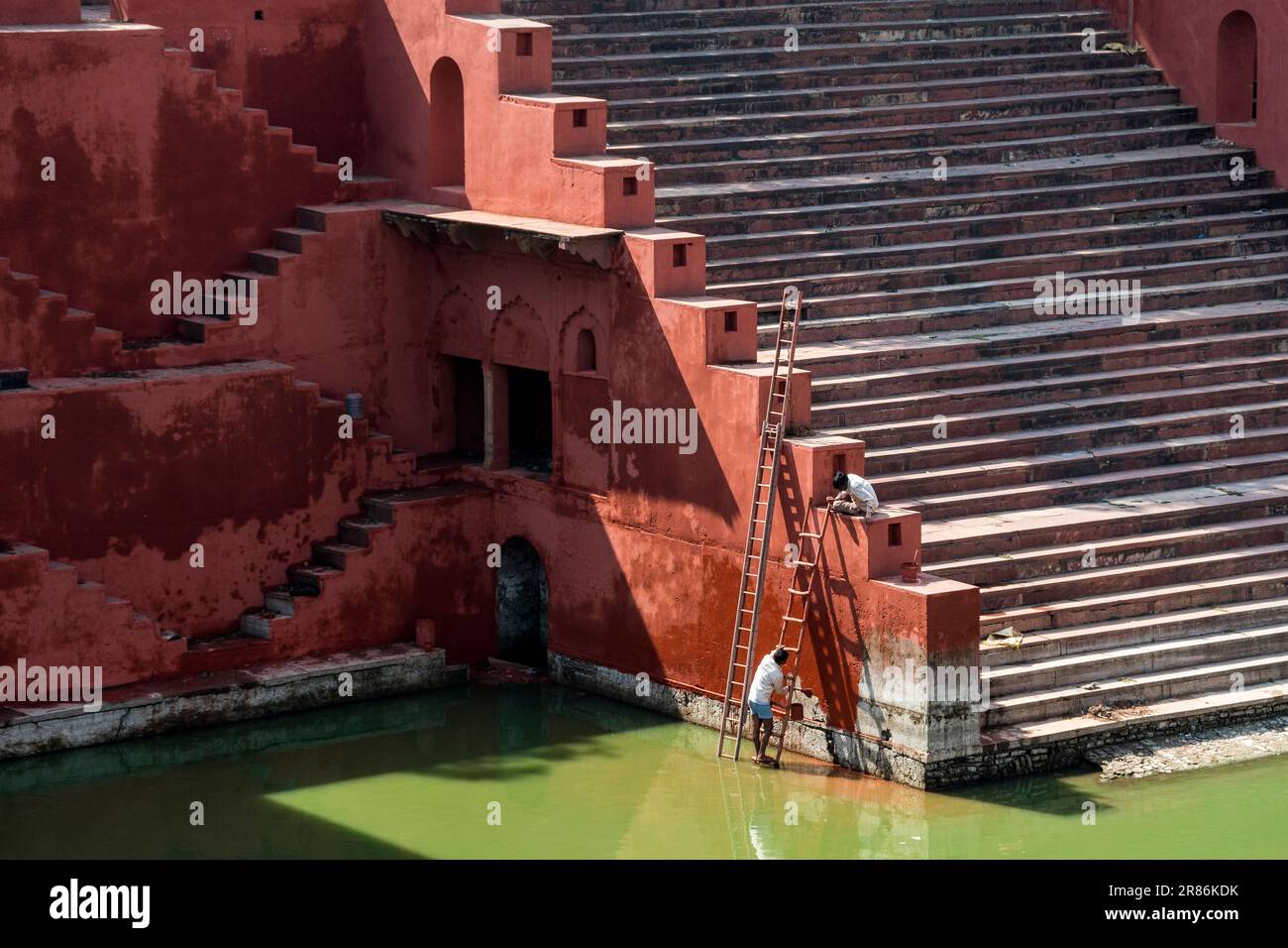 Workers paint the inside of Potra kund, in Mathura, India Stock Photo ...