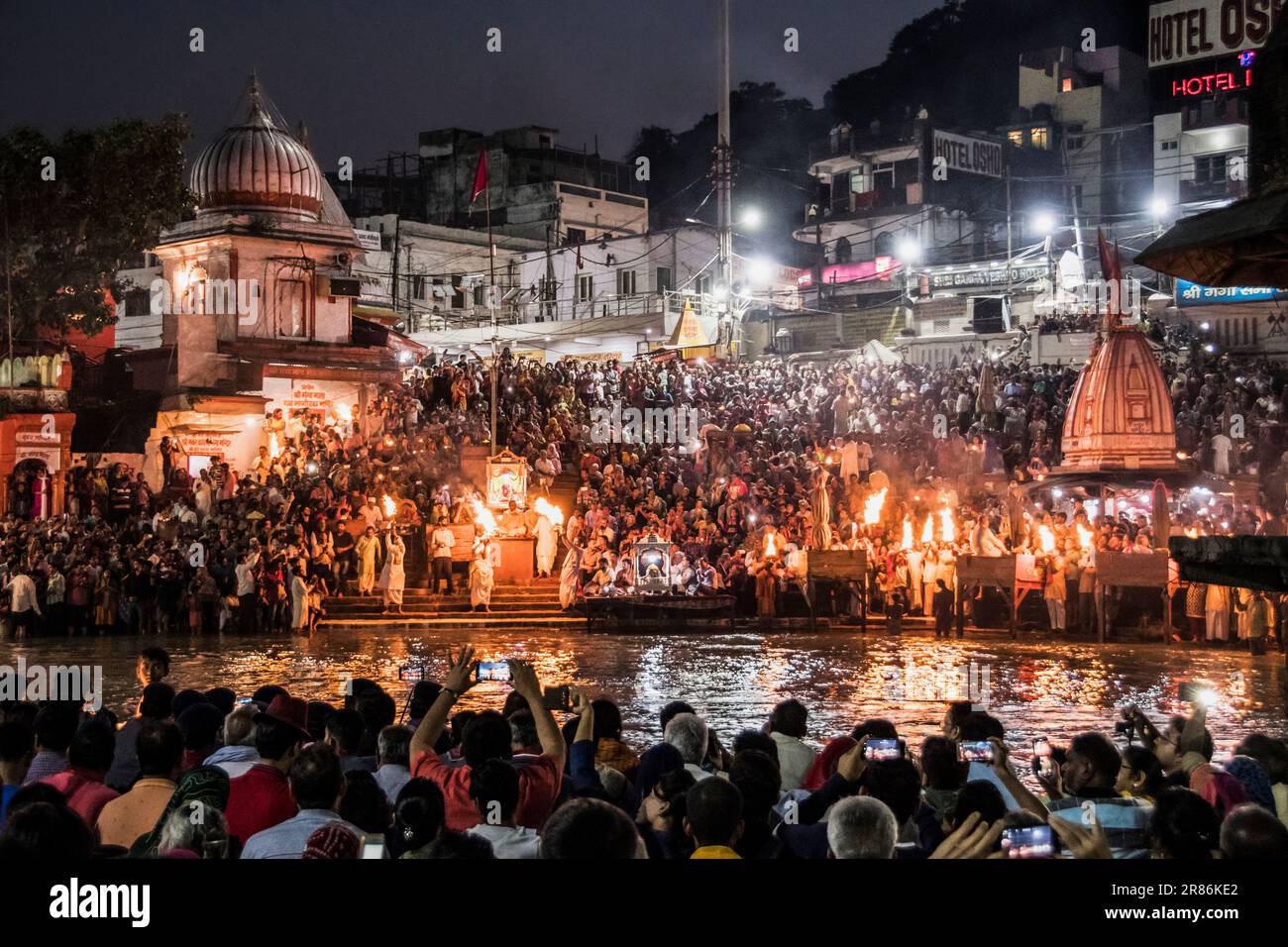 Pilgrims watch an Arti ceremony at Har Ki Pauri in Haridwar, India ...