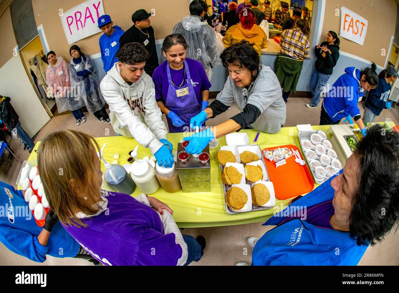 Volunteers prepare condiments for Mexican food at a Catholic church ...