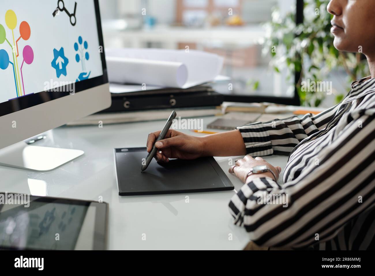 Hand of young African American graphic designer with stylus and ...