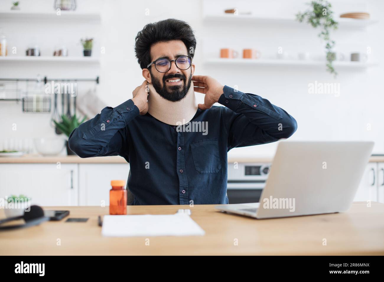 Aching mature person touching C collar supporting man's neck while ...