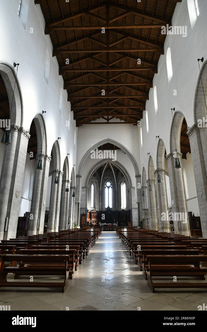 A traditional church interior with ornate architecture and empty pews ...