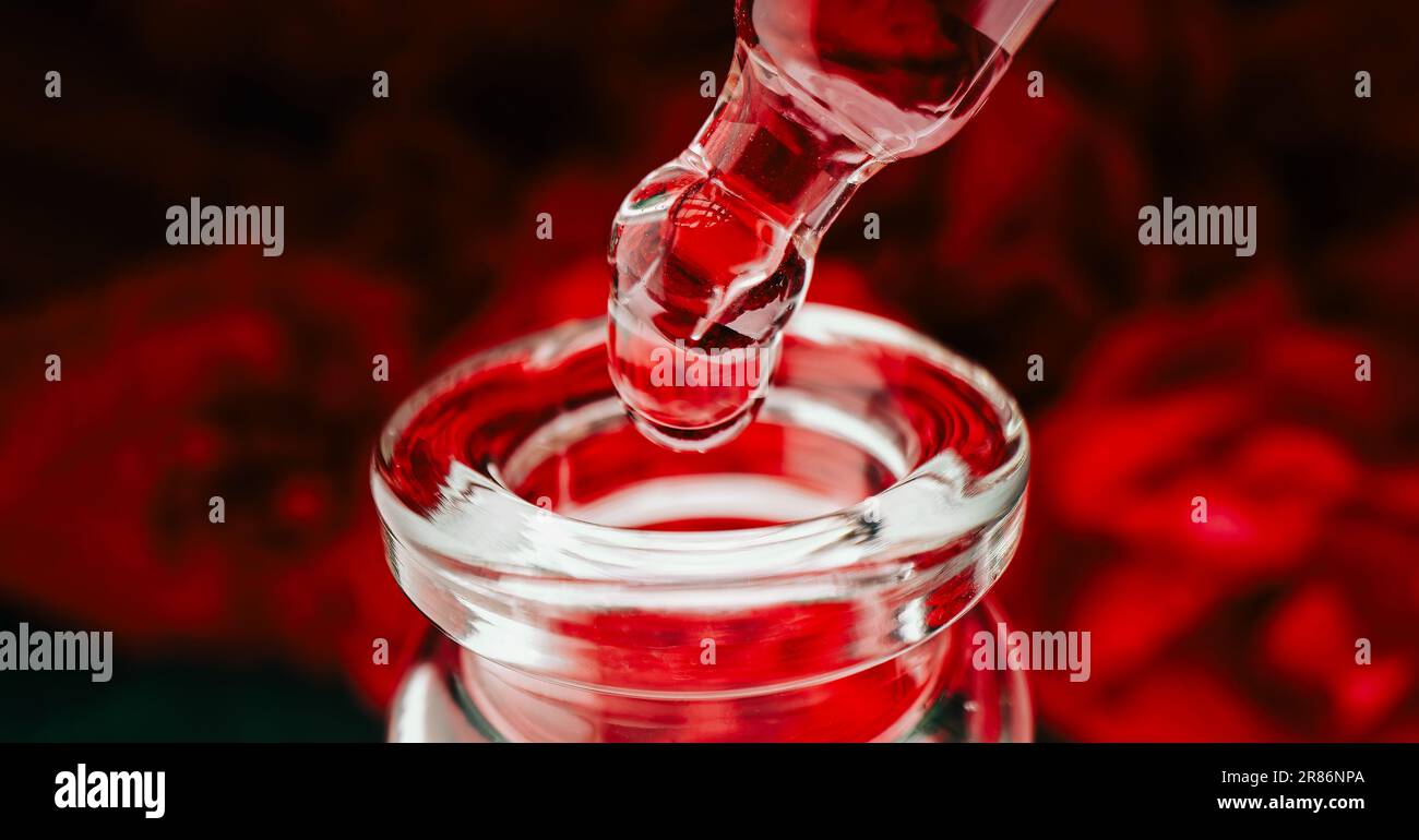 Acid peeling dripping from pipette into glass bottle.Abstract skin care ...