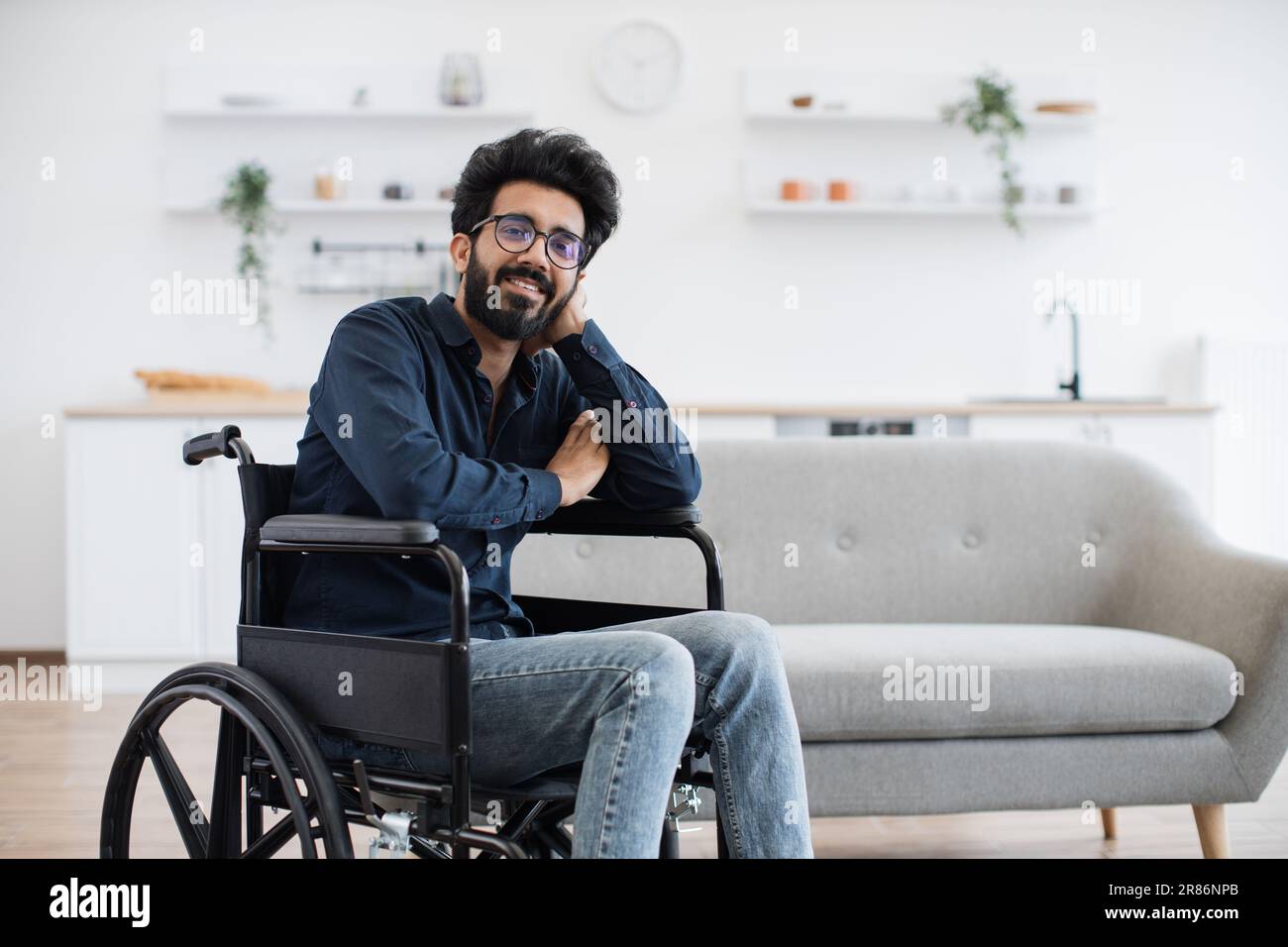 Young indian man in wheelchair hi-res stock photography and images - Alamy