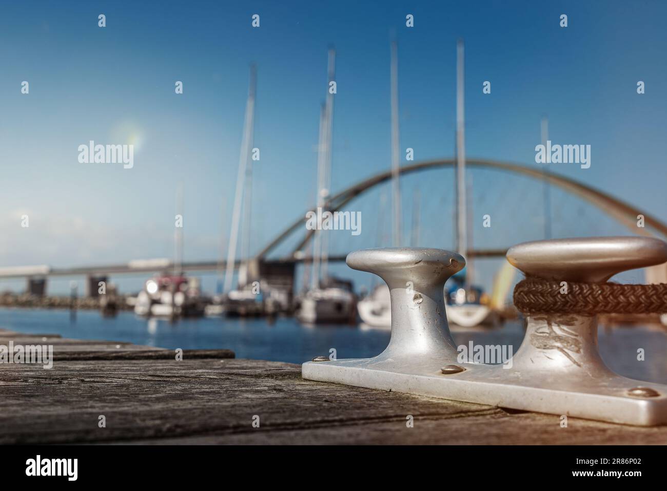 rope tied from a boat at the jetty of a sea port with beautiful ...