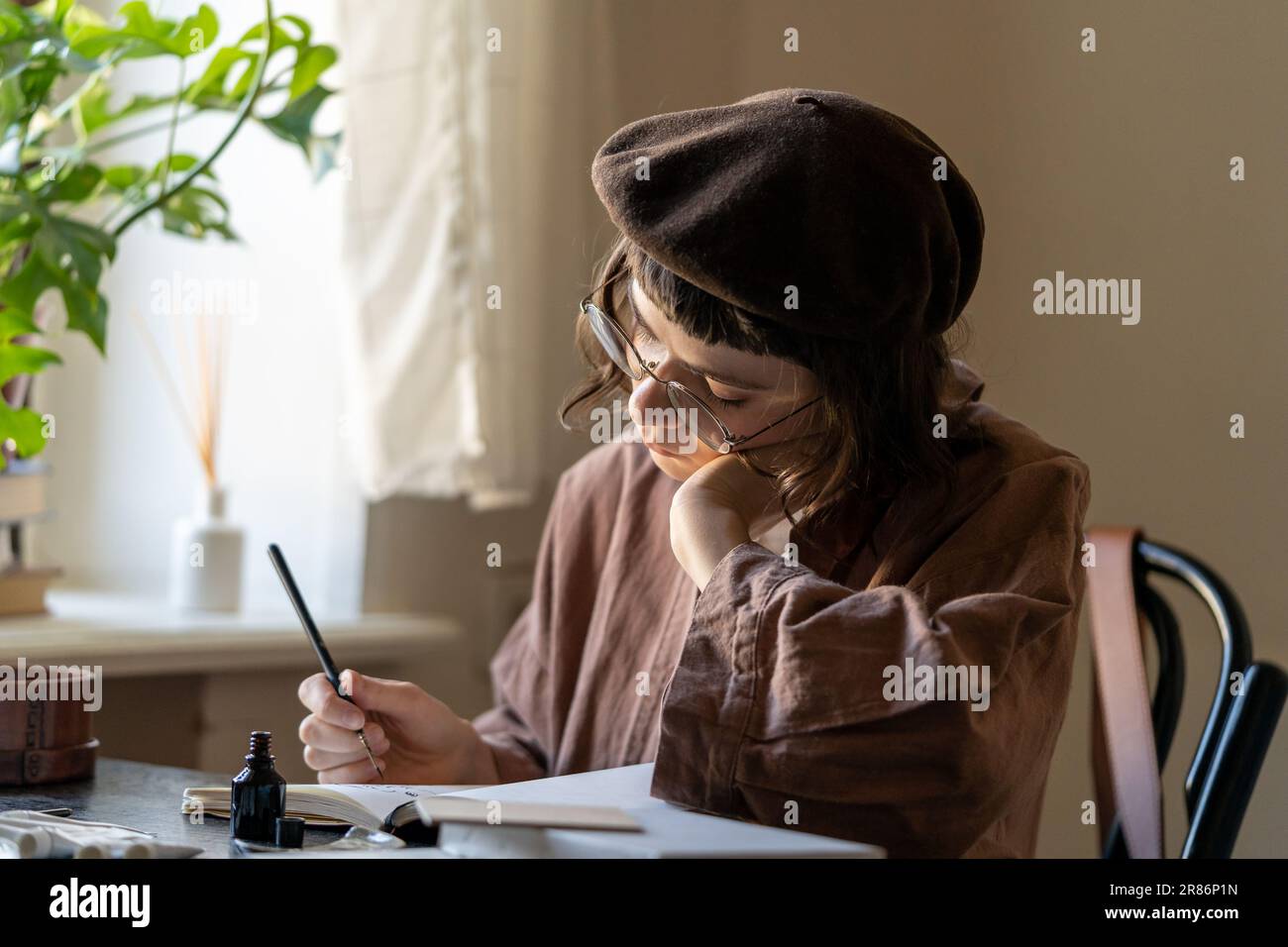 Female artist completely immersed in painting Stock Photo - Alamy