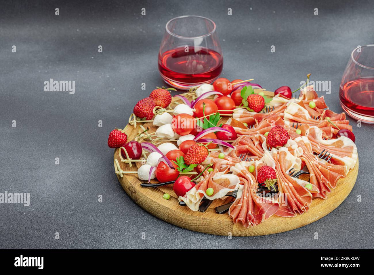 Set of picnic snacks on skewers. Jamon, mozzarella, cherry tomatoes ...