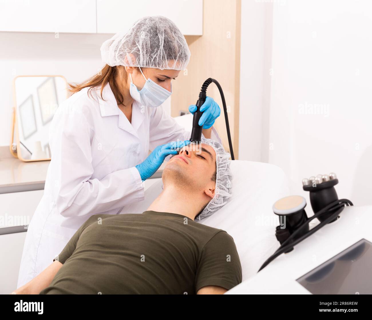 Man getting face skin rf lifting procedure Stock Photo - Alamy