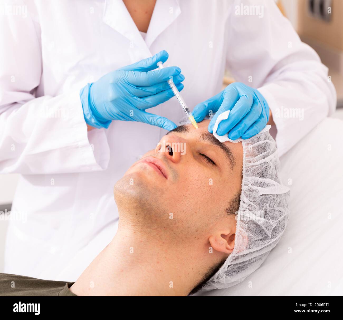 Man getting face injections at aesthetic clinic Stock Photo - Alamy