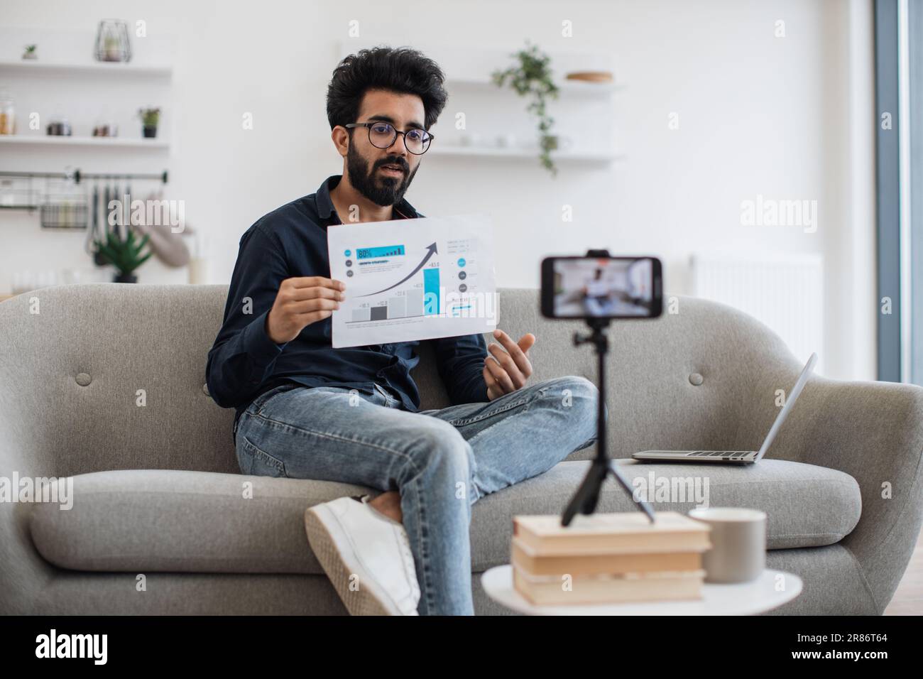 Enthusiastic lector of arab appearance in glasses teaching financial ...