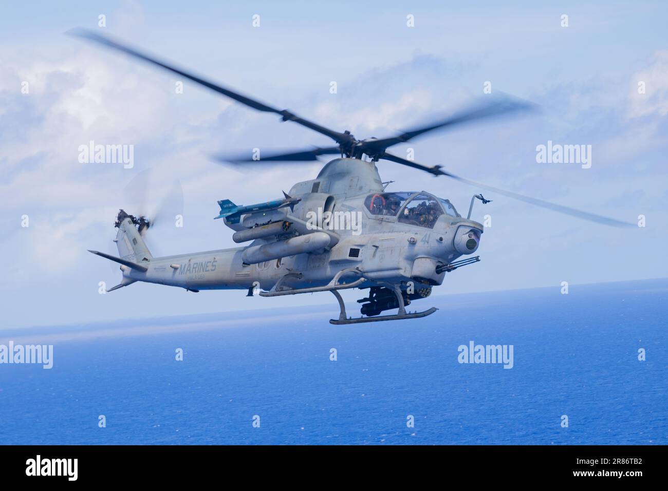 A U.S. Marine Corps AH-1W Cobra helicopter, with Medium Tiltrotor ...