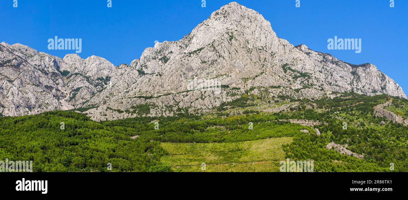 Greenery and grey hill and blue sky Stock Photo - Alamy