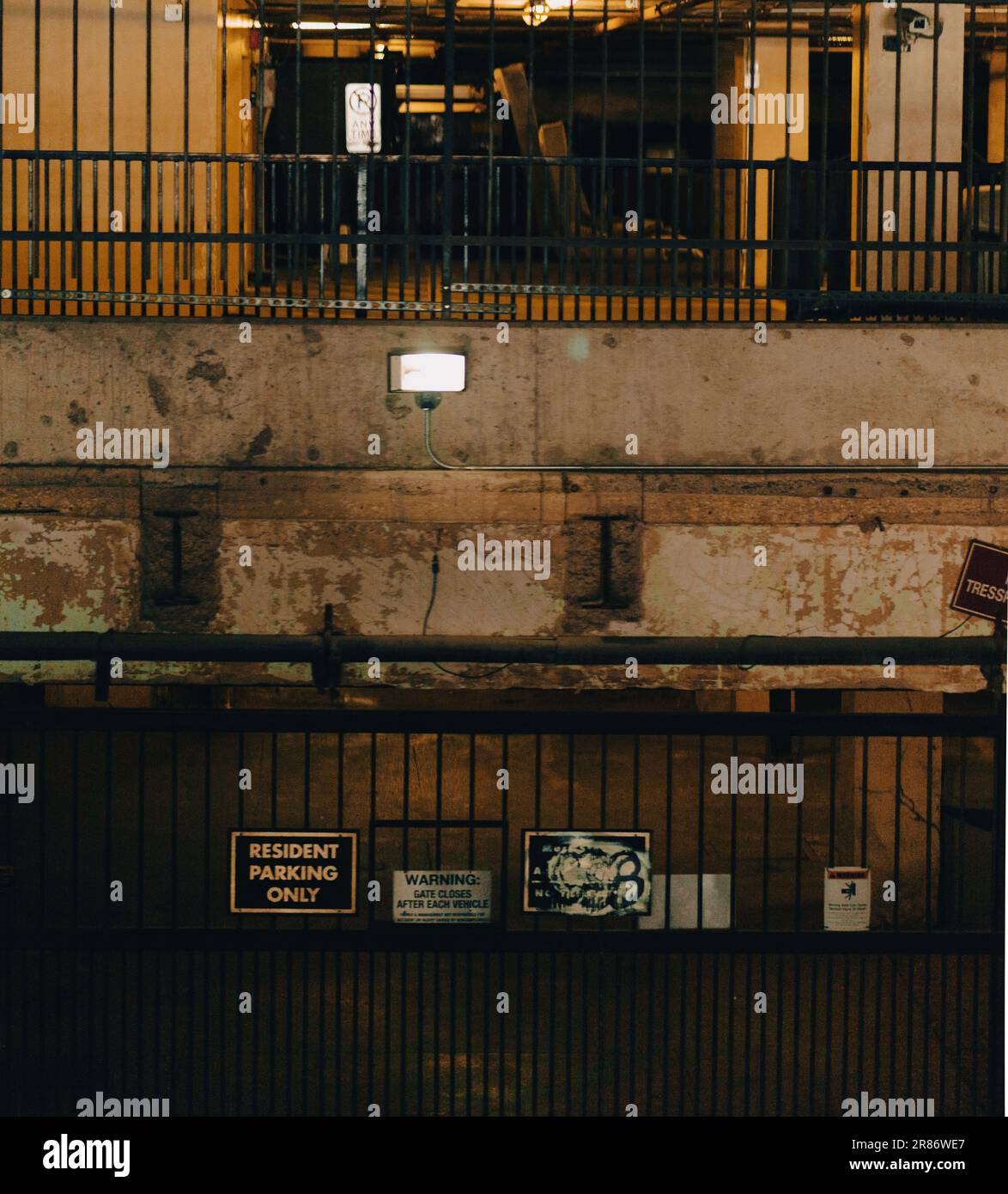 A vintage-style hallway featuring a white handrail and warning signs ...