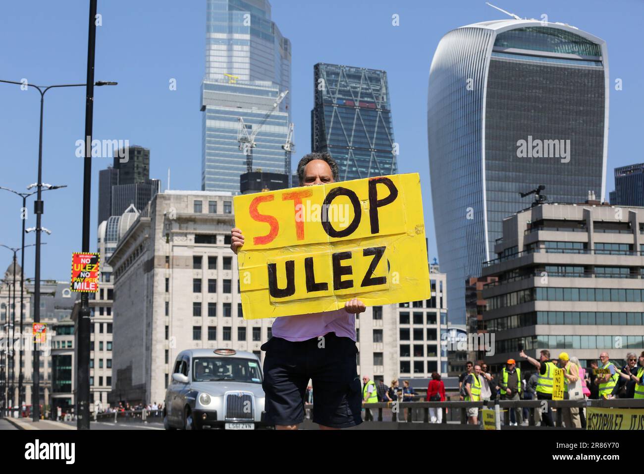 An anti ULEZ campaigner holds a sign on London Bridge during the ...