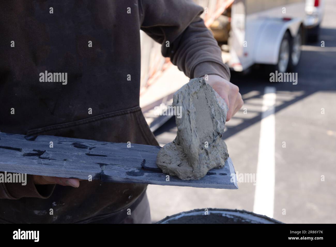 Spreading wet cement adhesive before applying tiles installation with ...