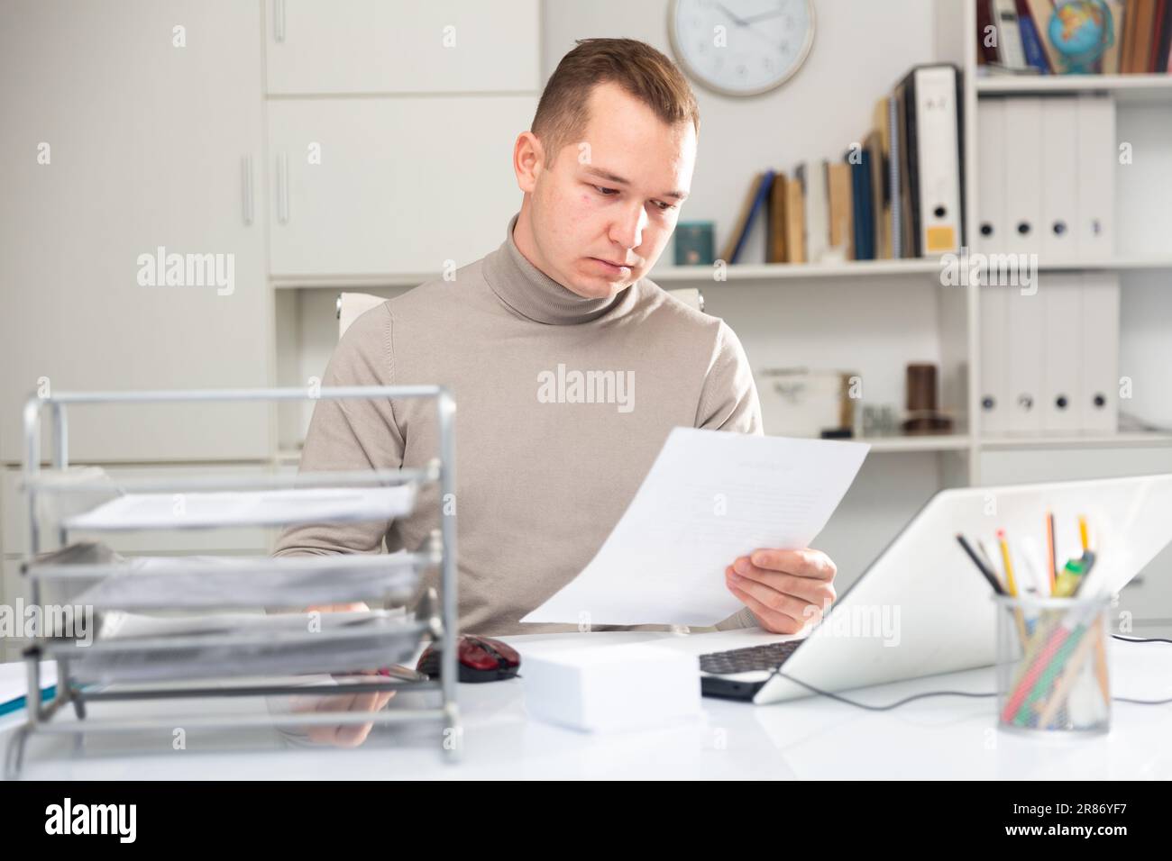 Male office worker doing paperwork Stock Photo - Alamy