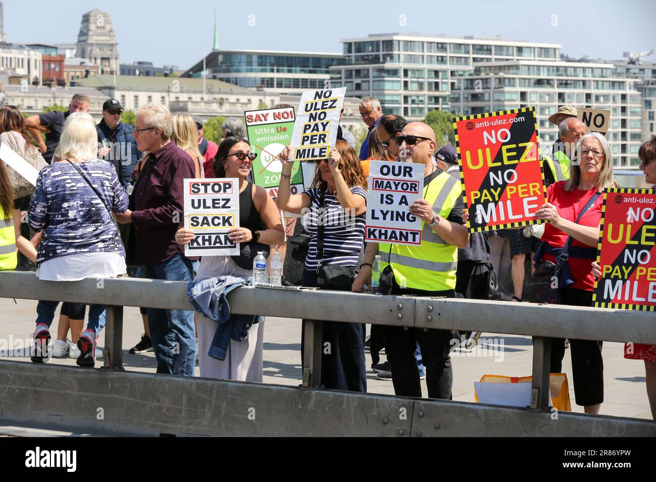 London, UK. 27th May, 2023. Anti ULEZ campaigners hold signs expressing ...