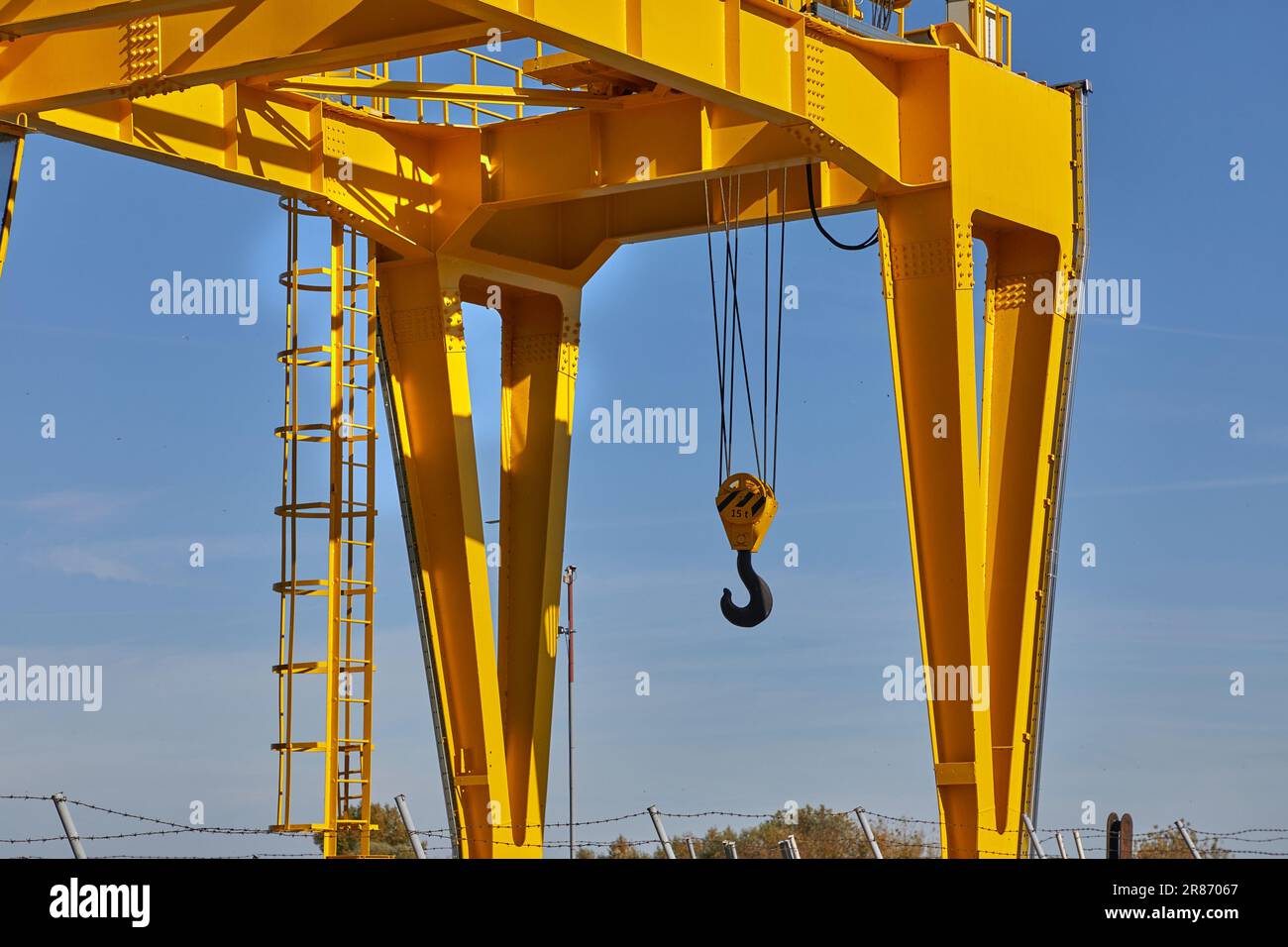 Crane with hooks hanging Stock Photo - Alamy