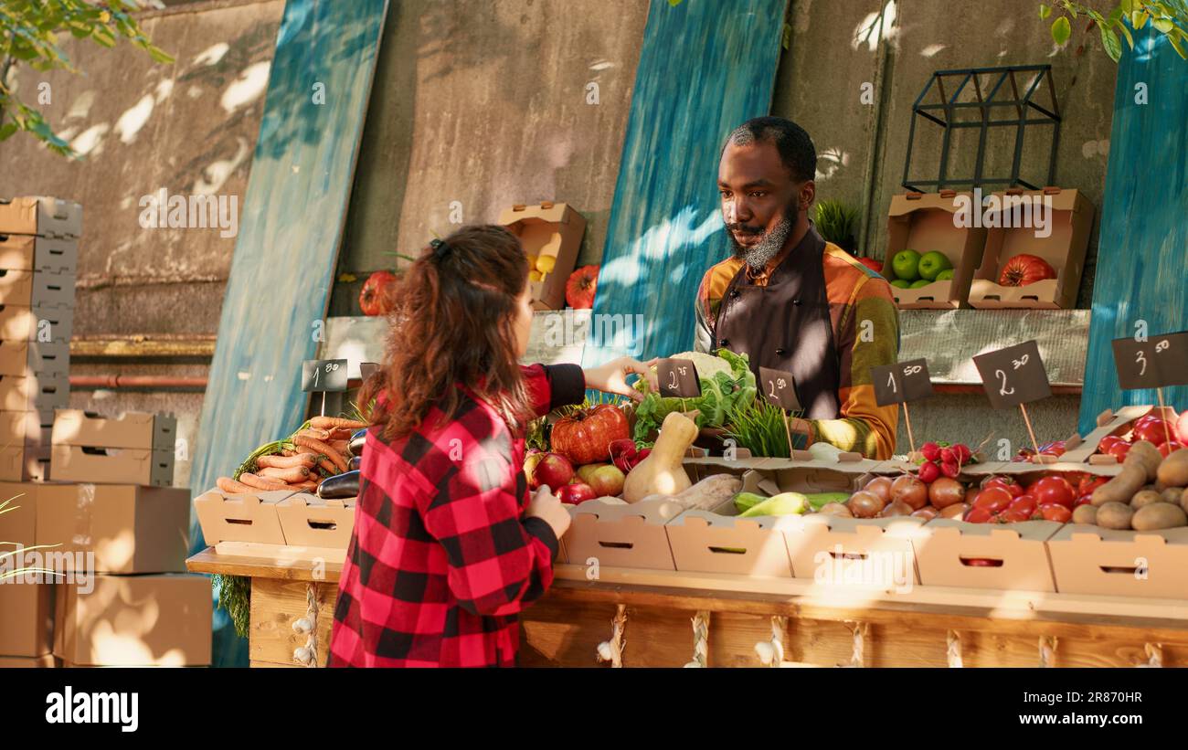 Diverse people talking about natural homegrown produce at farmers ...