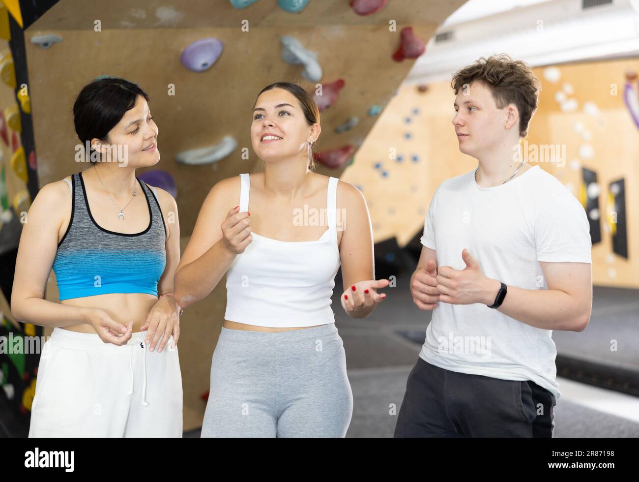 Asian girl, European woman and teenage guy - group of friends stand ...