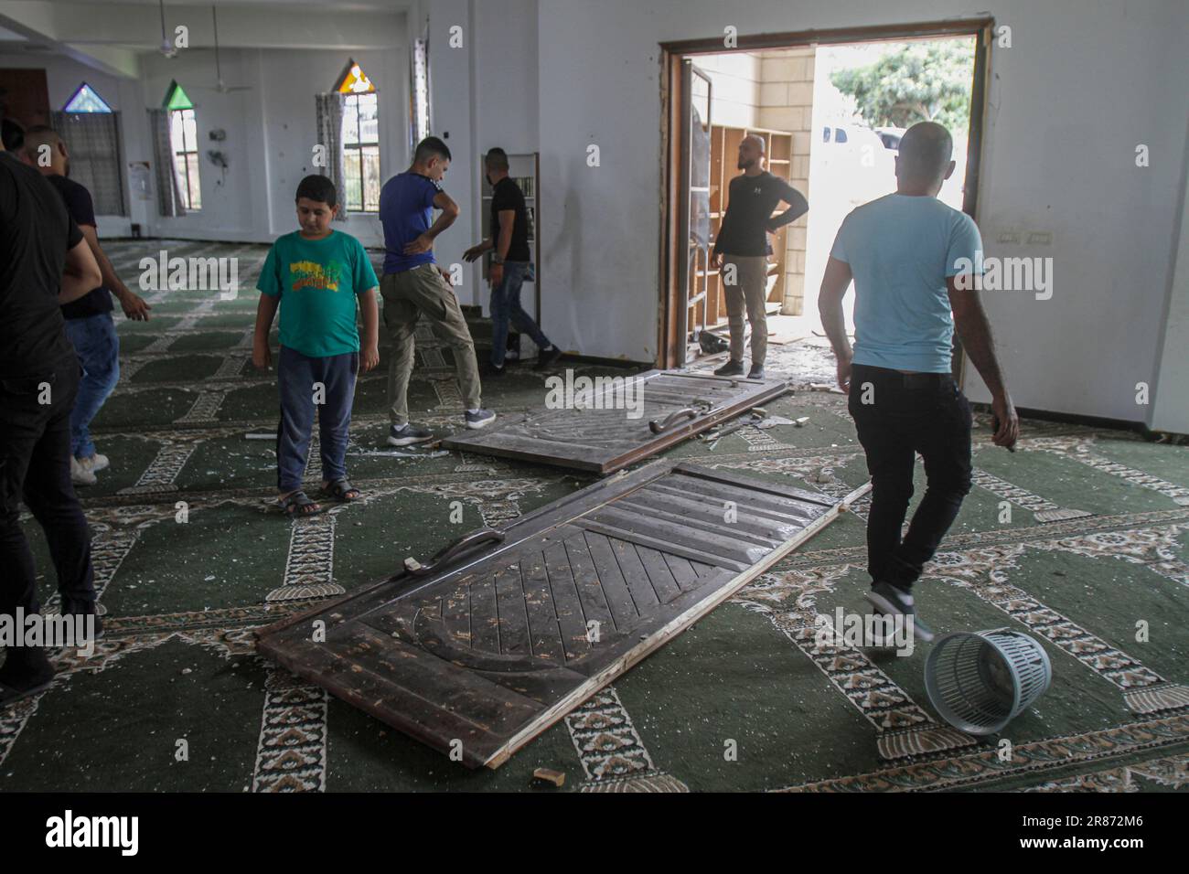 Palestinians inspect a destroyed mosque after Israeli helicopters ...