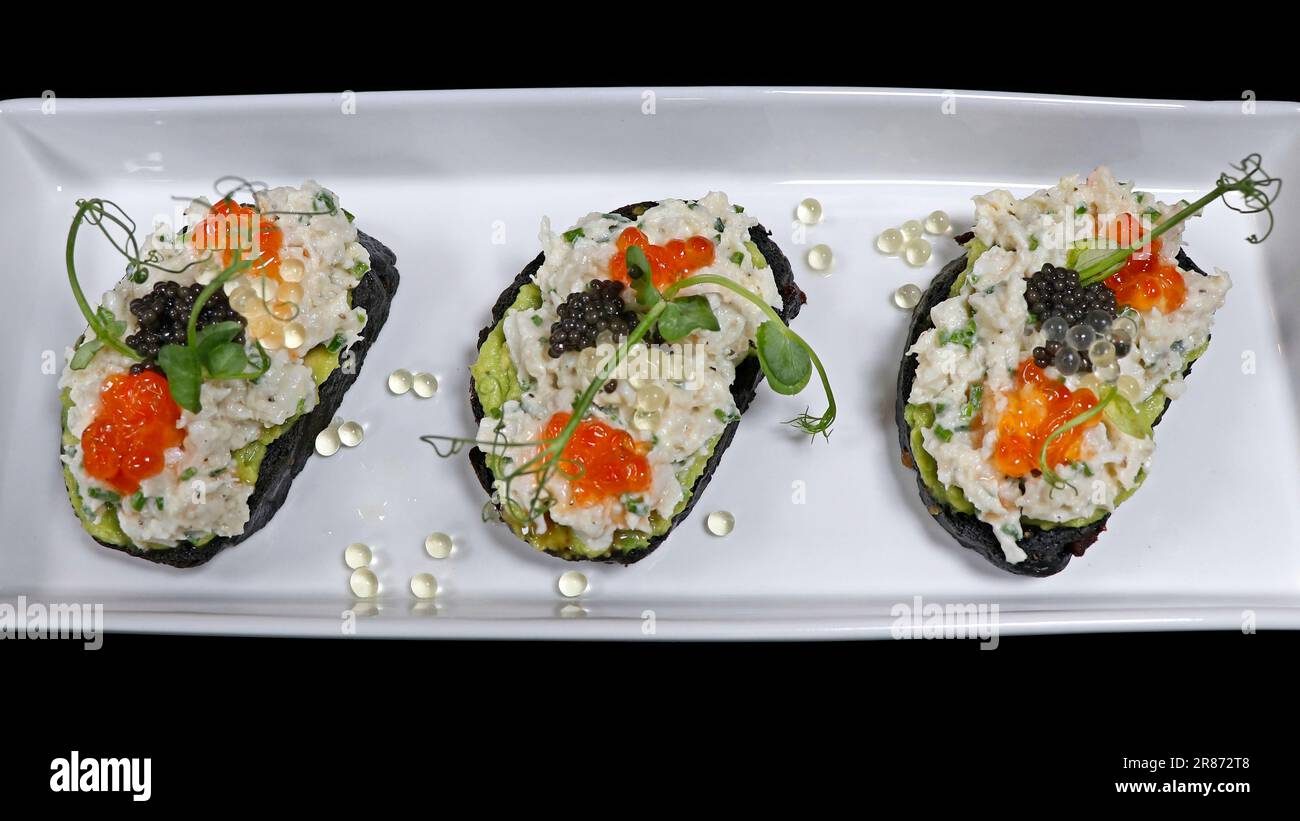 crab caviar tart with avocado spread and charcoal toast Stock Photo - Alamy